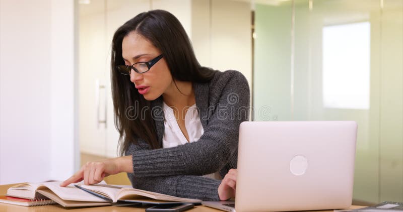 A College Student Does Her Homework on Her Laptop in the Library Stock ...
