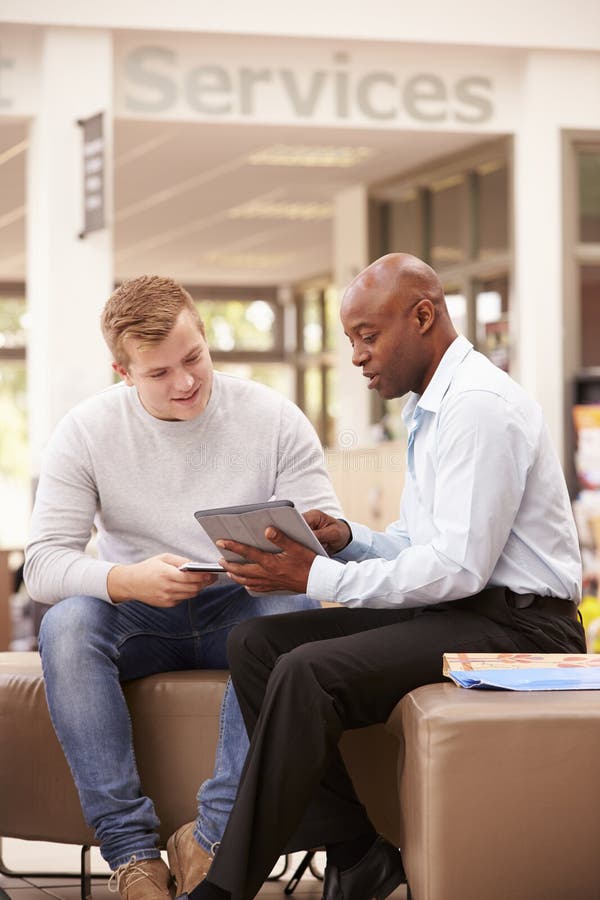 College Student Having Meeting with Tutor To Discuss Work Stock Image ...