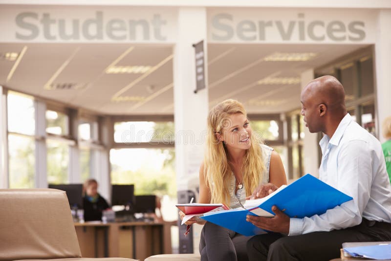 College Student Having Meeting with Tutor To Discuss Work Stock Photo ...