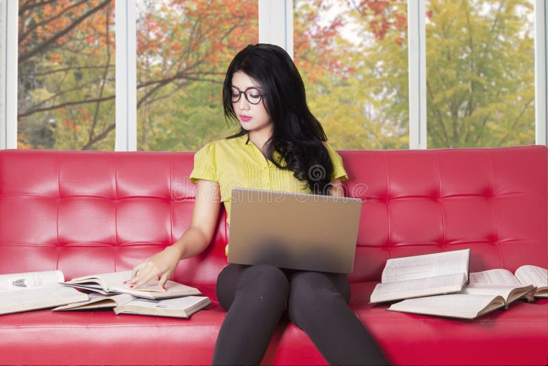 College Student with Laptop Reads Books on Sofa Stock Photo - Image of ...
