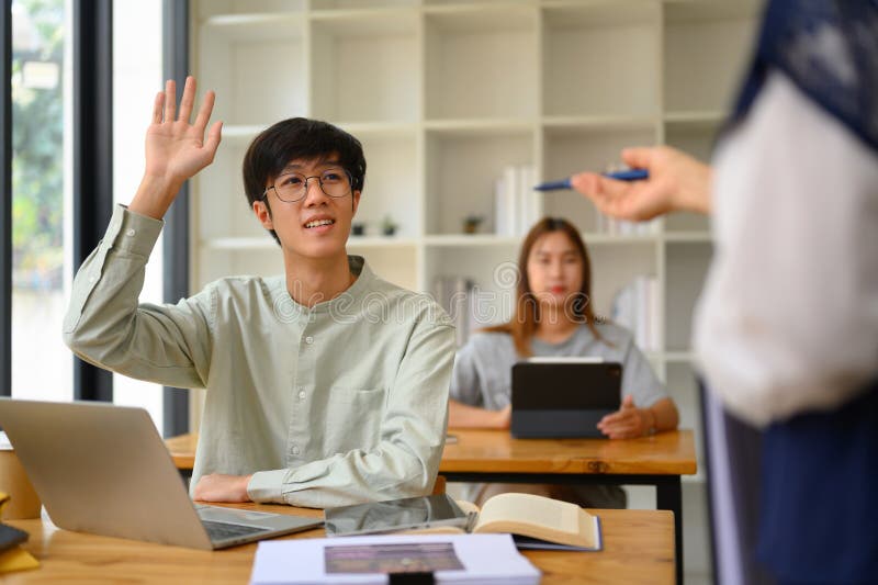 College Student Man Raising His Hand To Answer Question or Ask ...