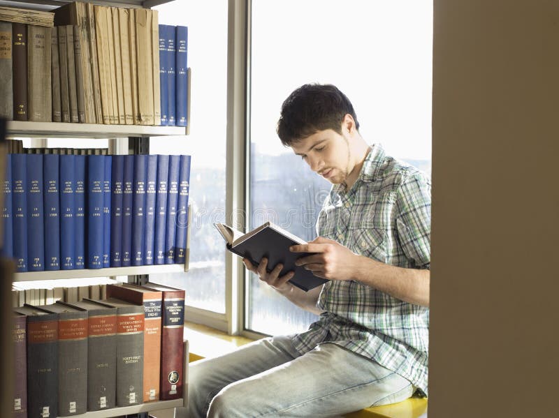 College Student Reading in Library Stock Photo - Image of person, male ...