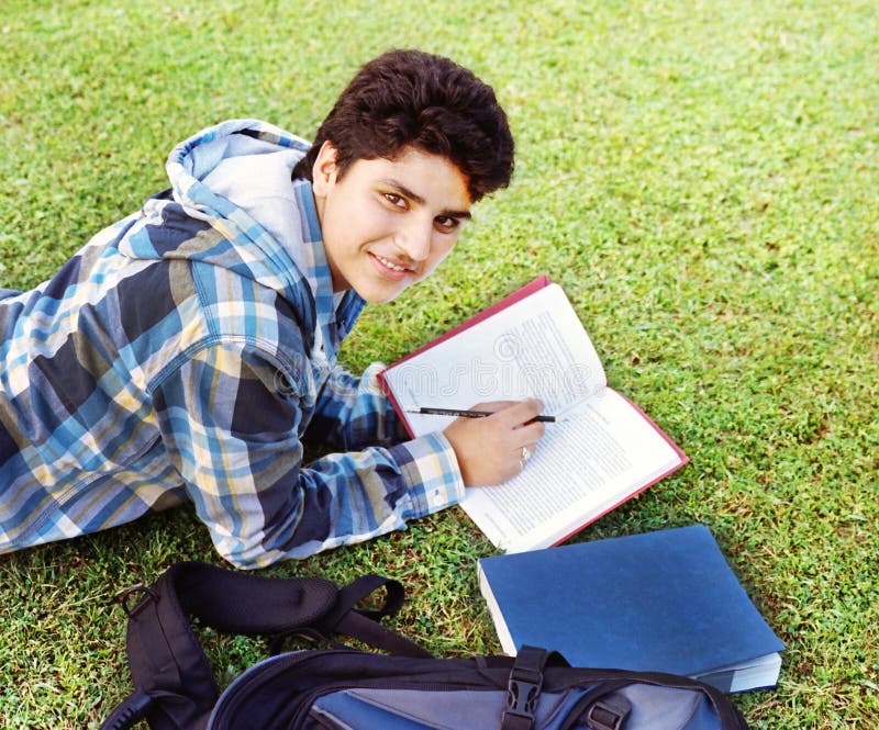 College Student Reading Over Grass. Stock Image - Image of notes ...