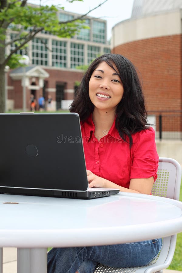 A Beautiful Asian College Student with Laptop on a University Campus ...