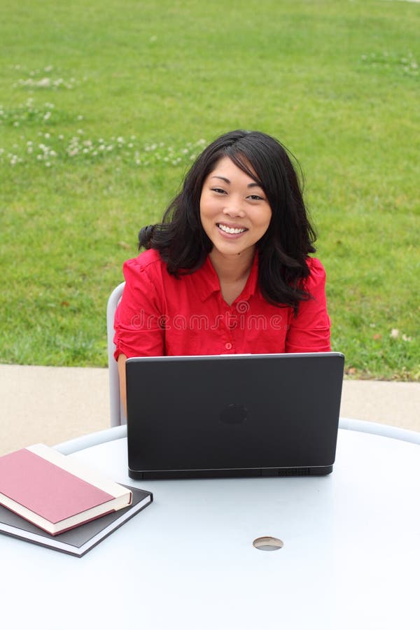 A Beautiful Asian College Student with Laptop on a University Campus ...