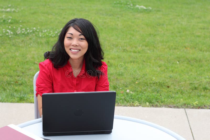 A Beautiful Asian College Student with Laptop on a University Campus ...