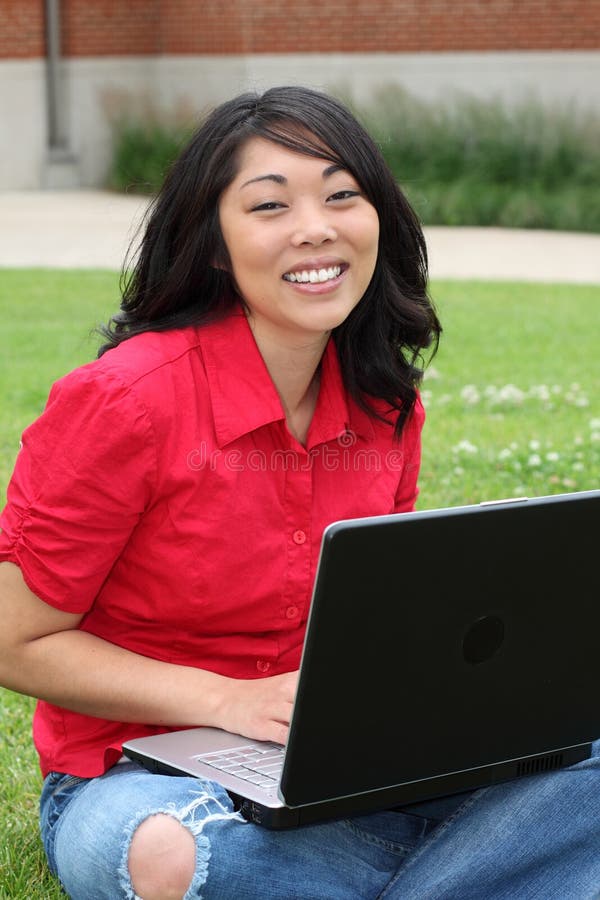 A Beautiful Asian College Student with Laptop on a University Campus ...