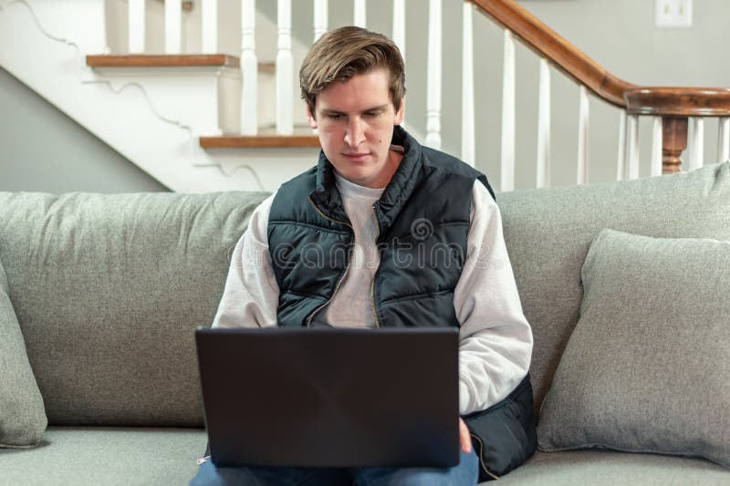 College Student Sitting on the Couch Using Laptop Stock Image - Image ...