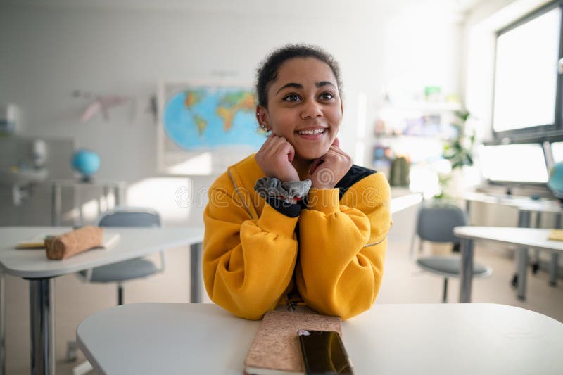 College Student Sitting in School-desk and Looking at Camera. Stock ...