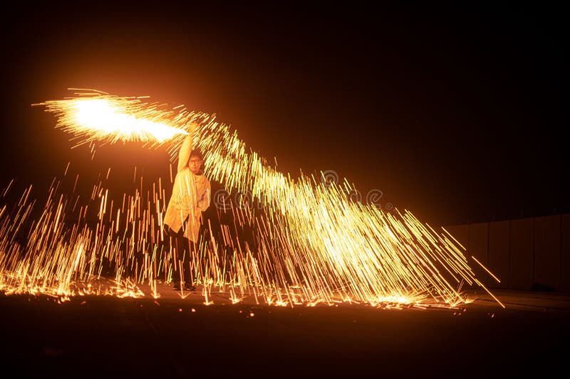 College Student Spinning Sparks during a Fire Performance at Night ...