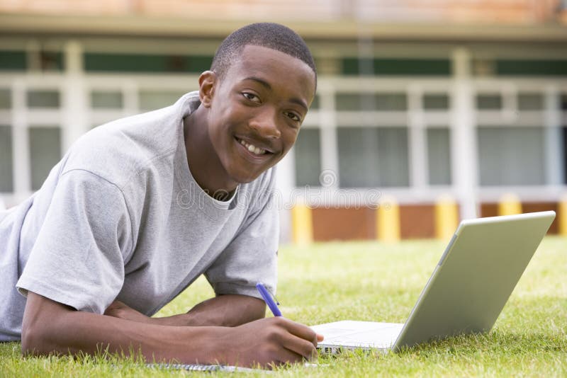College Student Using Laptop on Campus Lawn Stock Image - Image of ...