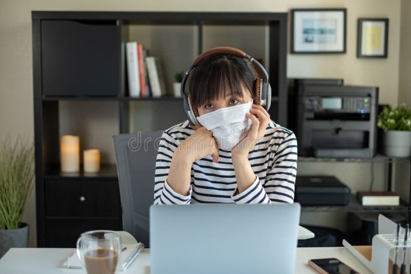 College Student Wear Mask and Work with the Computer at Home. Listening ...