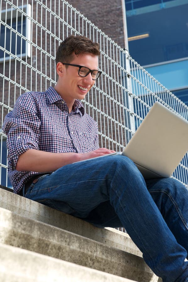 Portrait of a Happy Student Working on Laptop Outdoors Stock Image ...