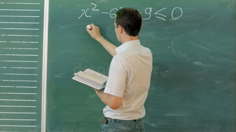 College Student Writing on the Chalkboard during a Math Class Stock ...