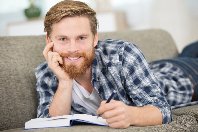 College Student Writing Down Note on Sofa Stock Photo - Image of ...