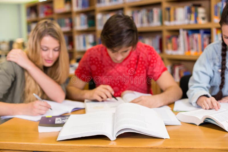 College Students Doing Homework in Library Stock Photo - Image of group ...