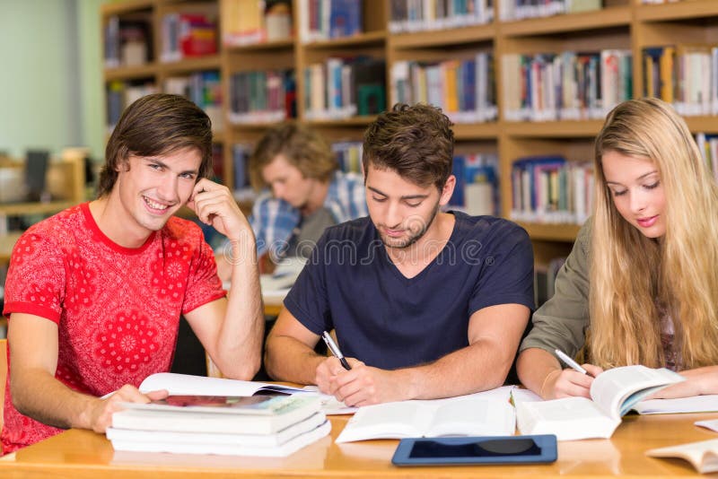 College Students Doing Homework in Library Stock Photo - Image of four ...