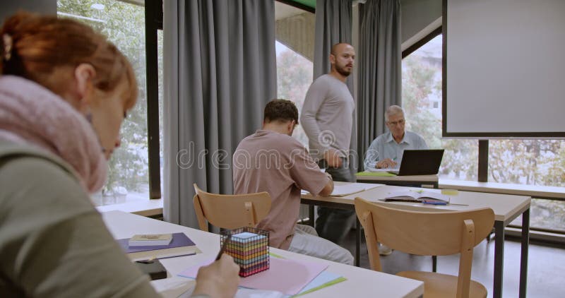 College Students Reviewing Class Material, Doing Homework, and Studying ...