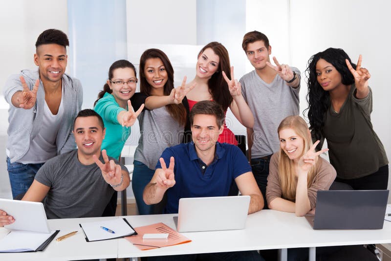 College Students Gesturing Victory Sign Together Stock Image - Image of ...