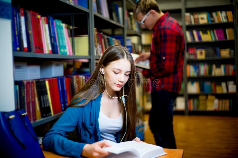 College Students in Library Stock Image - Image of serious, studying ...