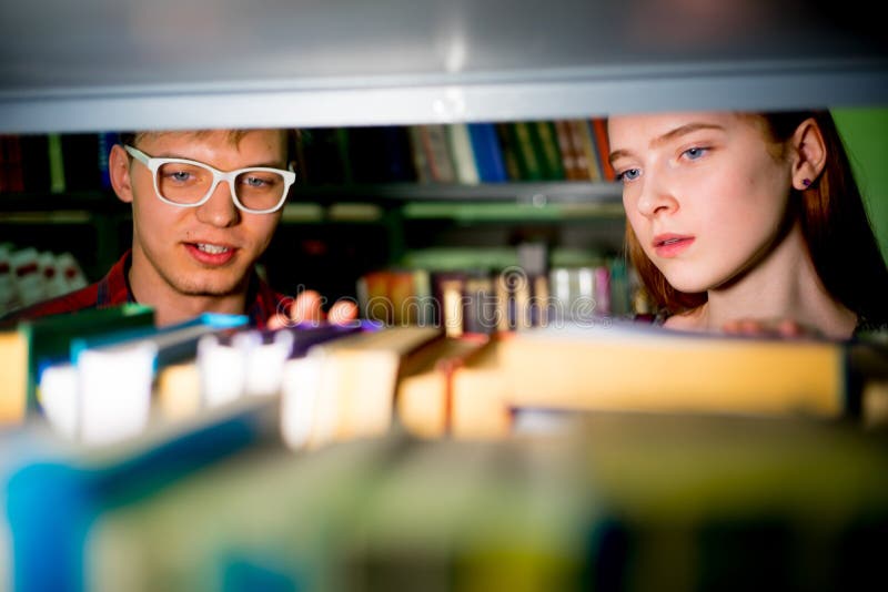 College Students in Library Stock Photo - Image of male, bookshelf ...