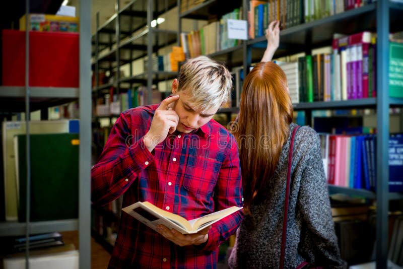 College Students in Library Stock Image - Image of serious, studying ...