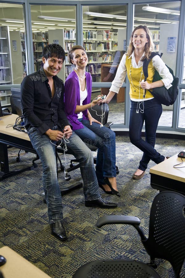 College Students with Music Players in Library Stock Image - Image of ...