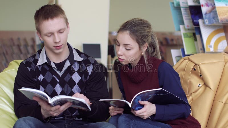 College Students Reading Magazines in Library Stock Footage - Video of ...