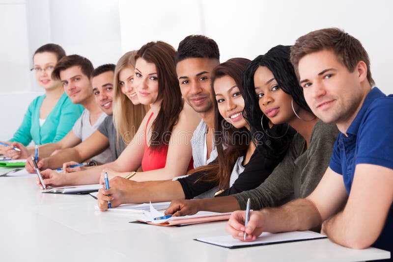 College Students Sitting in a Row at Desk Stock Image - Image of ...