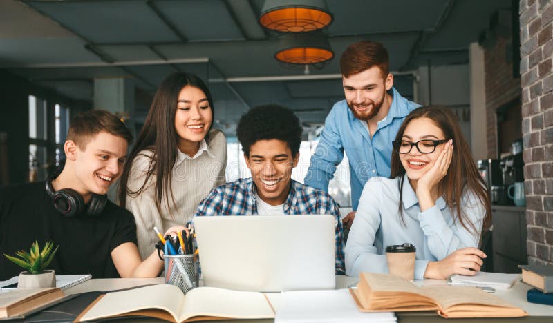 College Students Studying Together in Library, Using Laptop Stock Photo ...