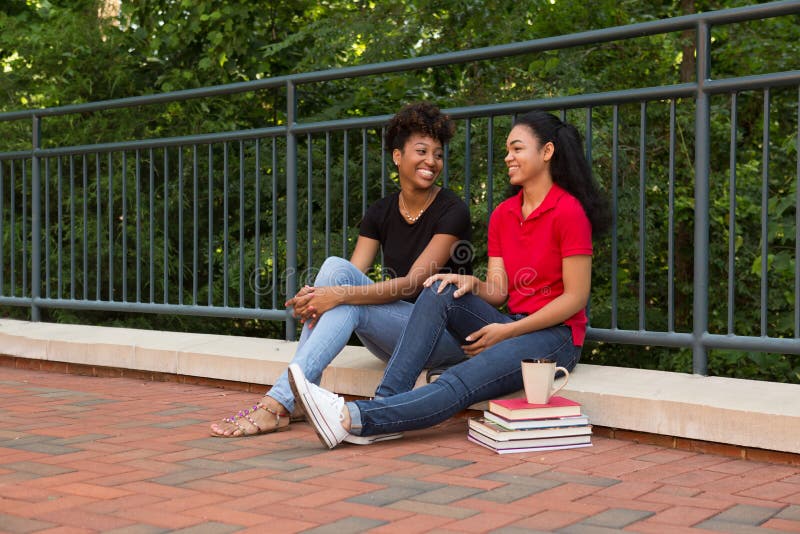 2 College Students Talking on Campus Stock Photo - Image of books ...