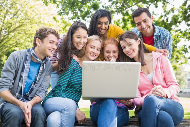 College Students Using Laptop in Park Stock Photo - Image of foreground ...