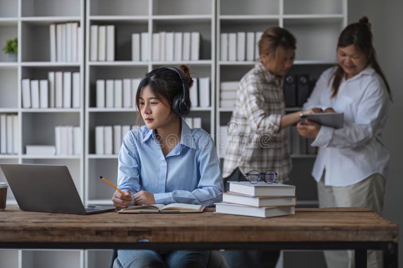 College Students Using Laptop while Sitting at Table. Group Study for ...