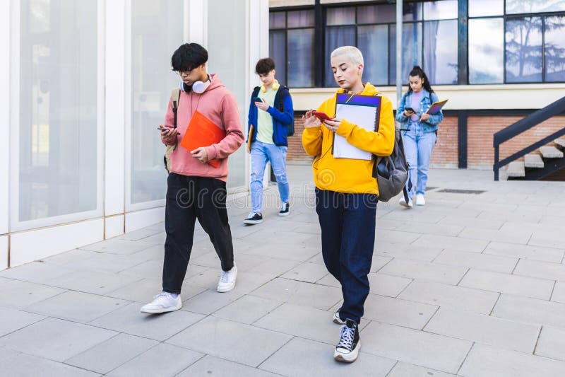 College Students Using Mobile Phone after Classes Outdoors. Stock Photo ...