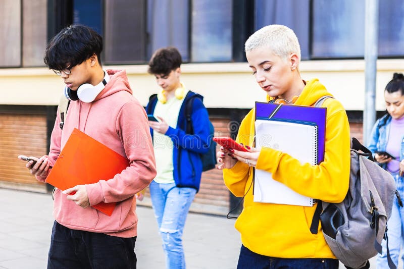 College Students Using Mobile Phone after Classes Outdoors. Stock Photo ...