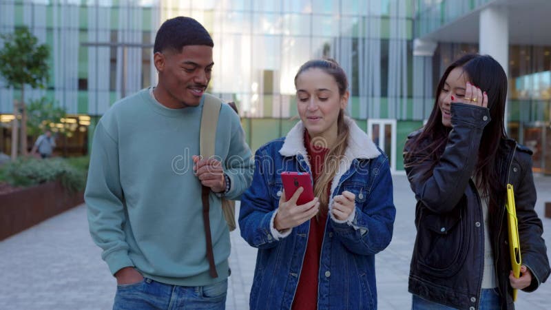 College Students Using Mobile Phone while Walking at University Campus ...