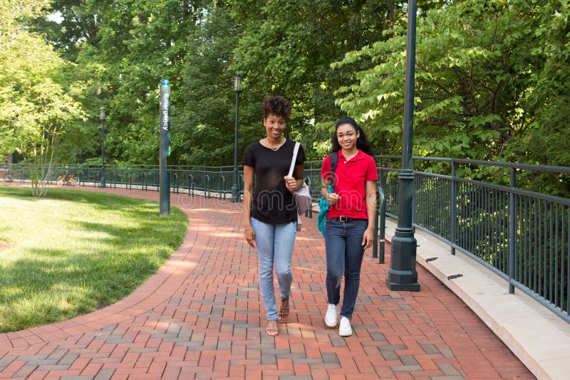 2 College Students Walking on Campus Stock Photo - Image of happy ...
