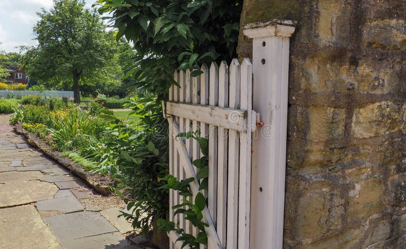 Colonial Village Gate Courtyard Event Stock Image - Image of flowers ...