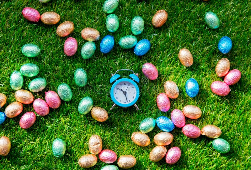 Color Chocolate Easter Eggs and Alarm Clock Stock Photo - Image of eggs ...