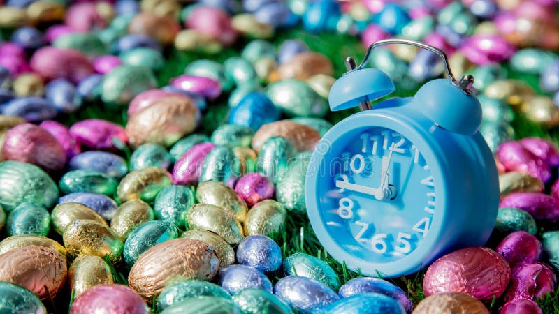 Color Chocolate Easter Eggs and Alarm Clock Stock Photo - Image of ...