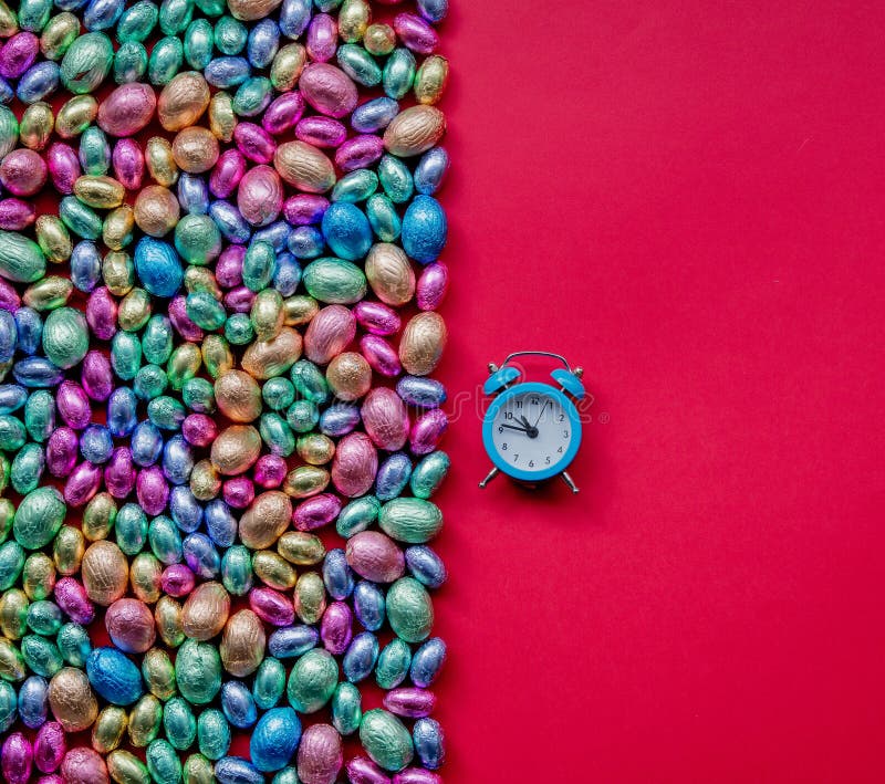 Color Chocolate Easter Eggs and Alarm Clock Stock Photo - Image of ...