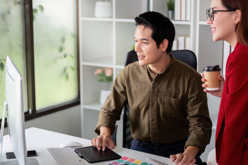 Color Exploration and Team Engagement. Designers Collaborate at a Computer, Discussing ...