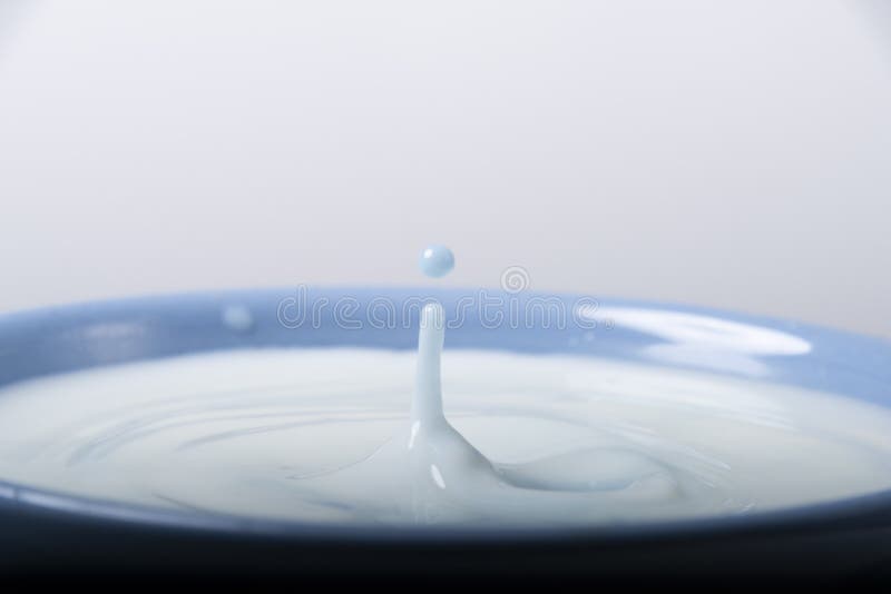 Color Fresh Blue Milk Drops into White Milk in Cup with White ...