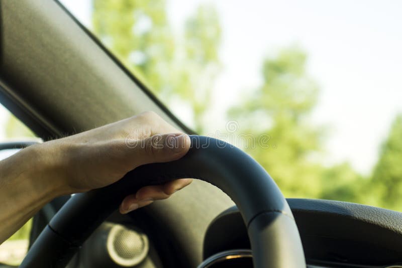 Color Image of Two Hands Holding a Steering Wheel Inside a Car. Stock ...