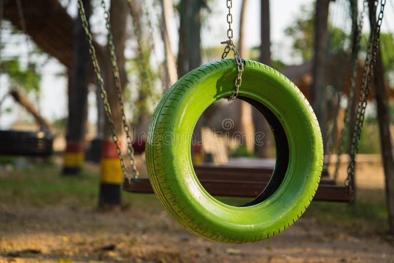Color Old Car Tire Hanging On Tree At Playground Stock Image - Image of ...