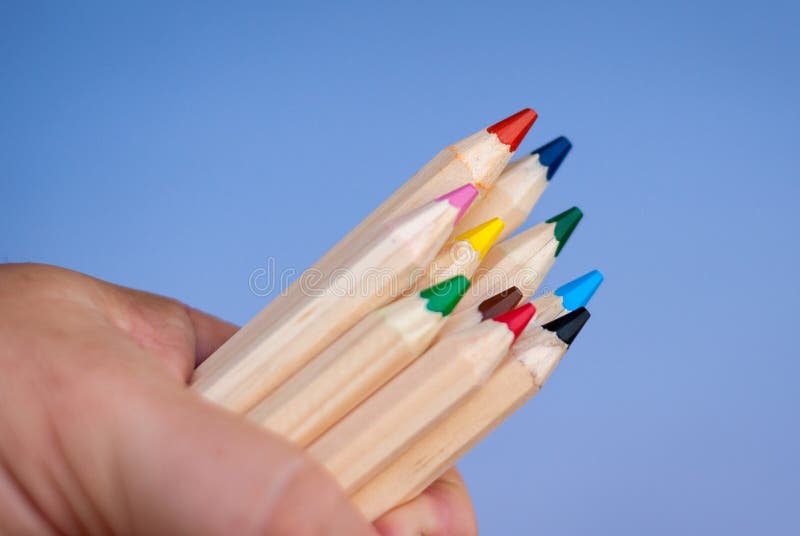 Color pencils in hand stock photo. Image of equipment - 76049598