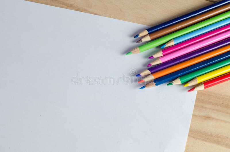 Color Pencils on White Paper on the Table. View from Above Stock Image ...