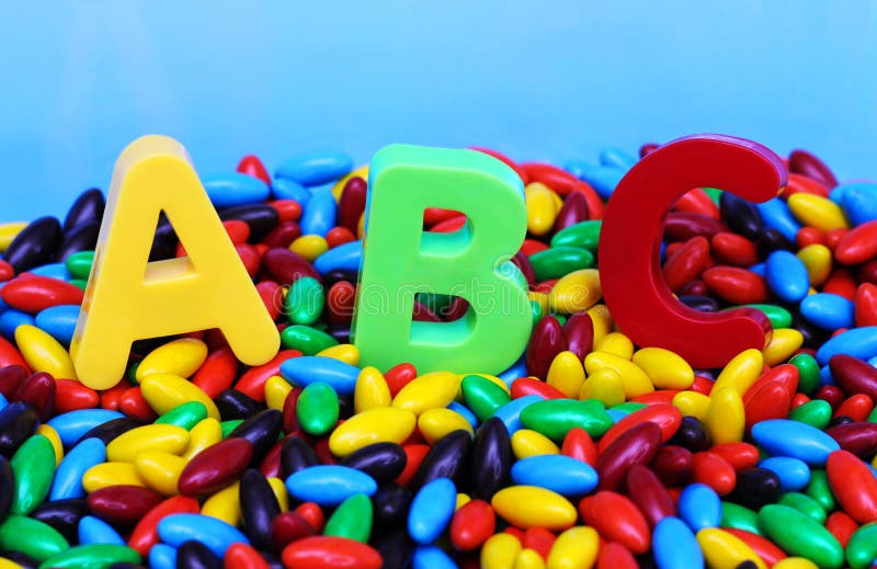 Colored ABC Letters are Placed on Colored Candies Stock Image - Image ...