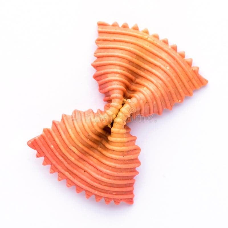 Colored Bow Tie Pasta. Closeup Single Orange Farfalle on White ...