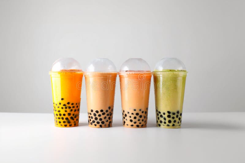 Colored Bubble Tea Drinks in Plastic Cups with Tapioca Balls on White ...